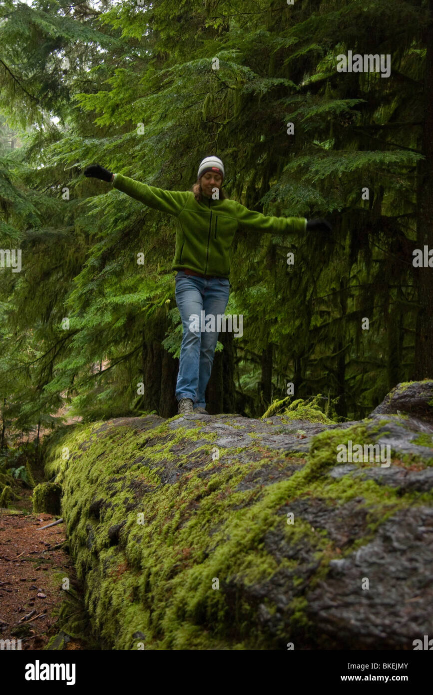 Woman balancing on a fallen log in the forest, BC, Canada Stock Photo ...