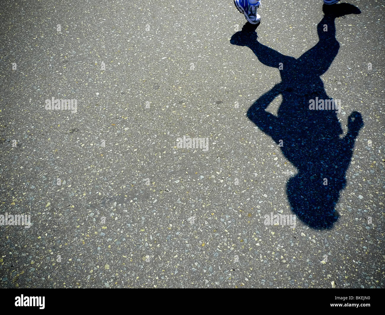 Shadows of runner's legs whilst competing in marathon road race Stock ...
