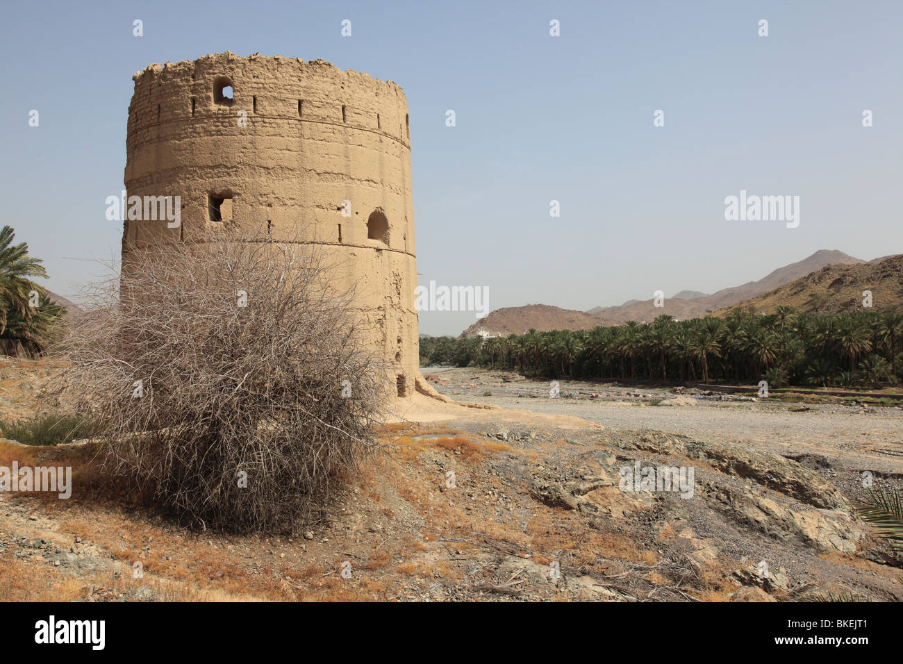 traditional old watchtower in wadi of old Fanja, Hajar al Gharbi ...