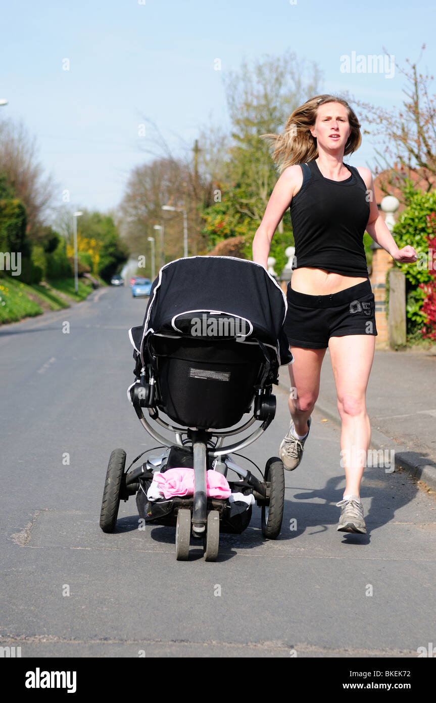 Young Mother Running With Child in Pushchair Stock Photo - Alamy