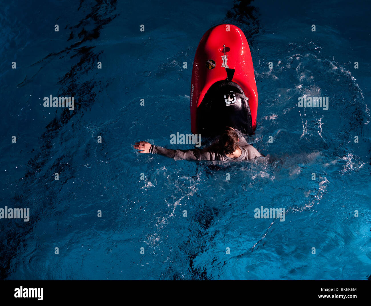 Freestyle Whitewater Kayaker cartwheeling a red kayak paddle-free, Ulm ...