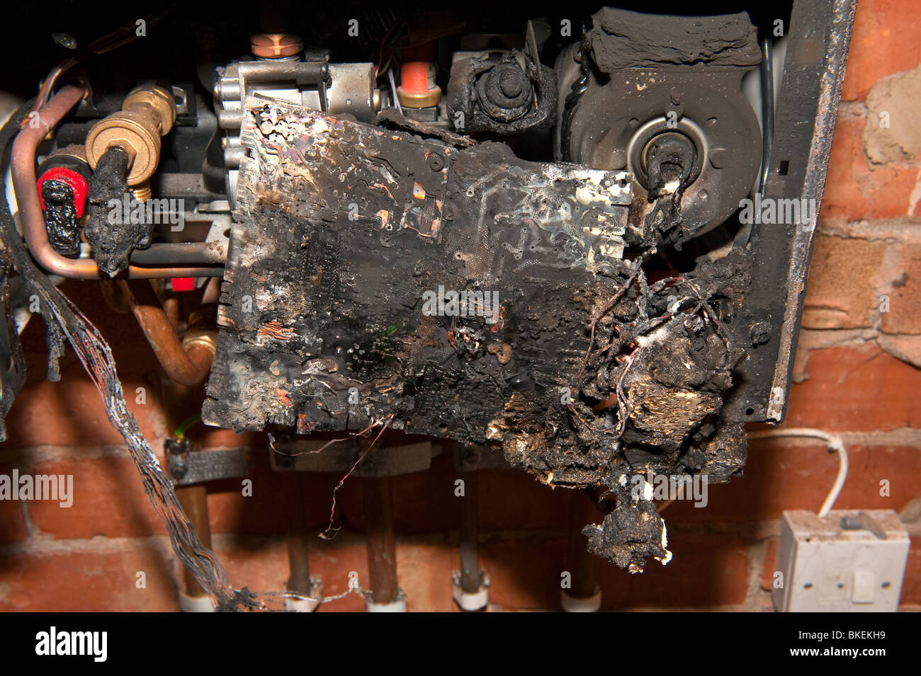 Burnt out domestic boiler and control panel following fire caused by ...
