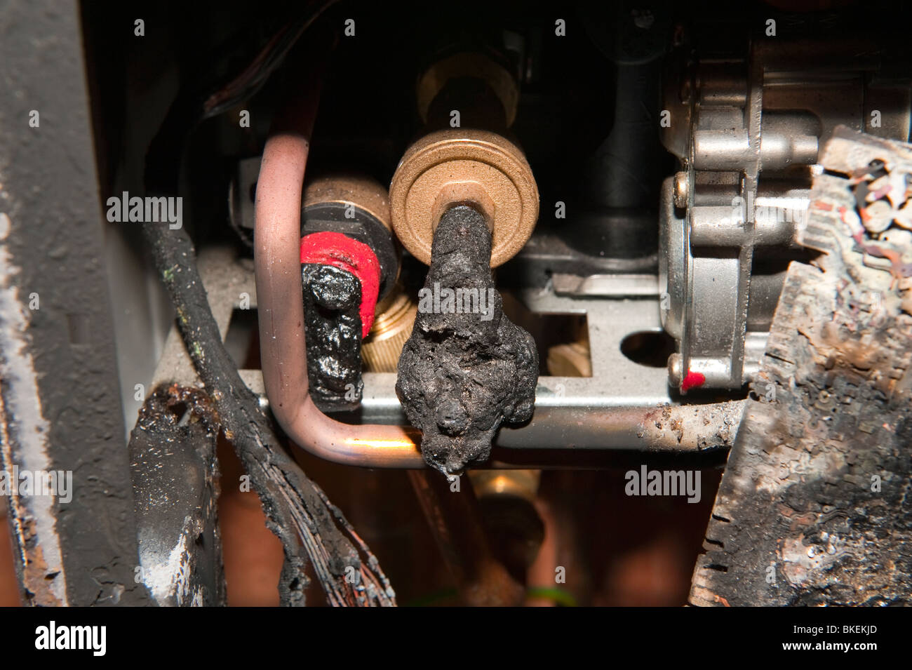 Burnt out domestic boiler and control panel following fire caused by ...
