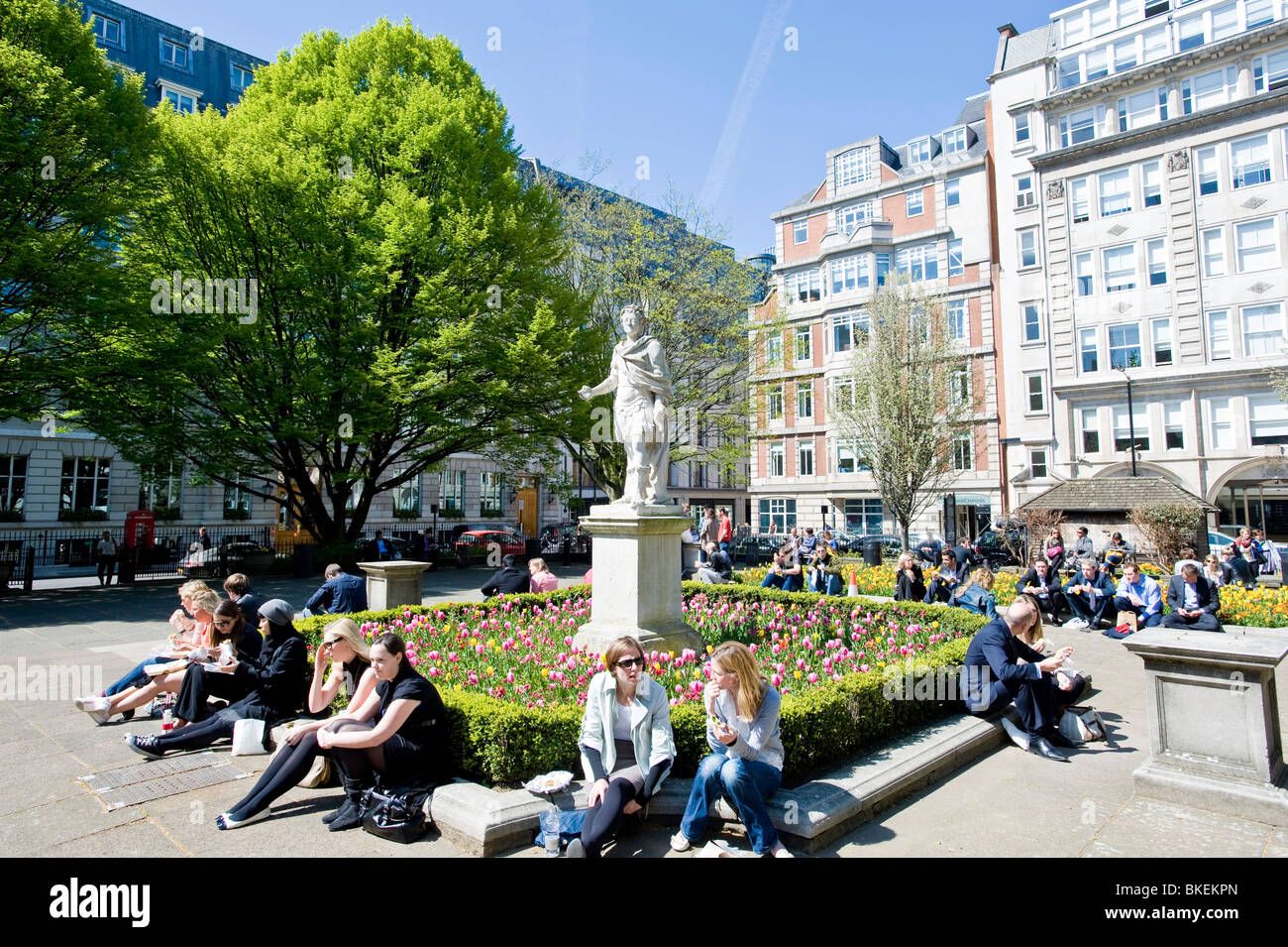 People resting on warm spring day in Golden Square, W1, London, United ...