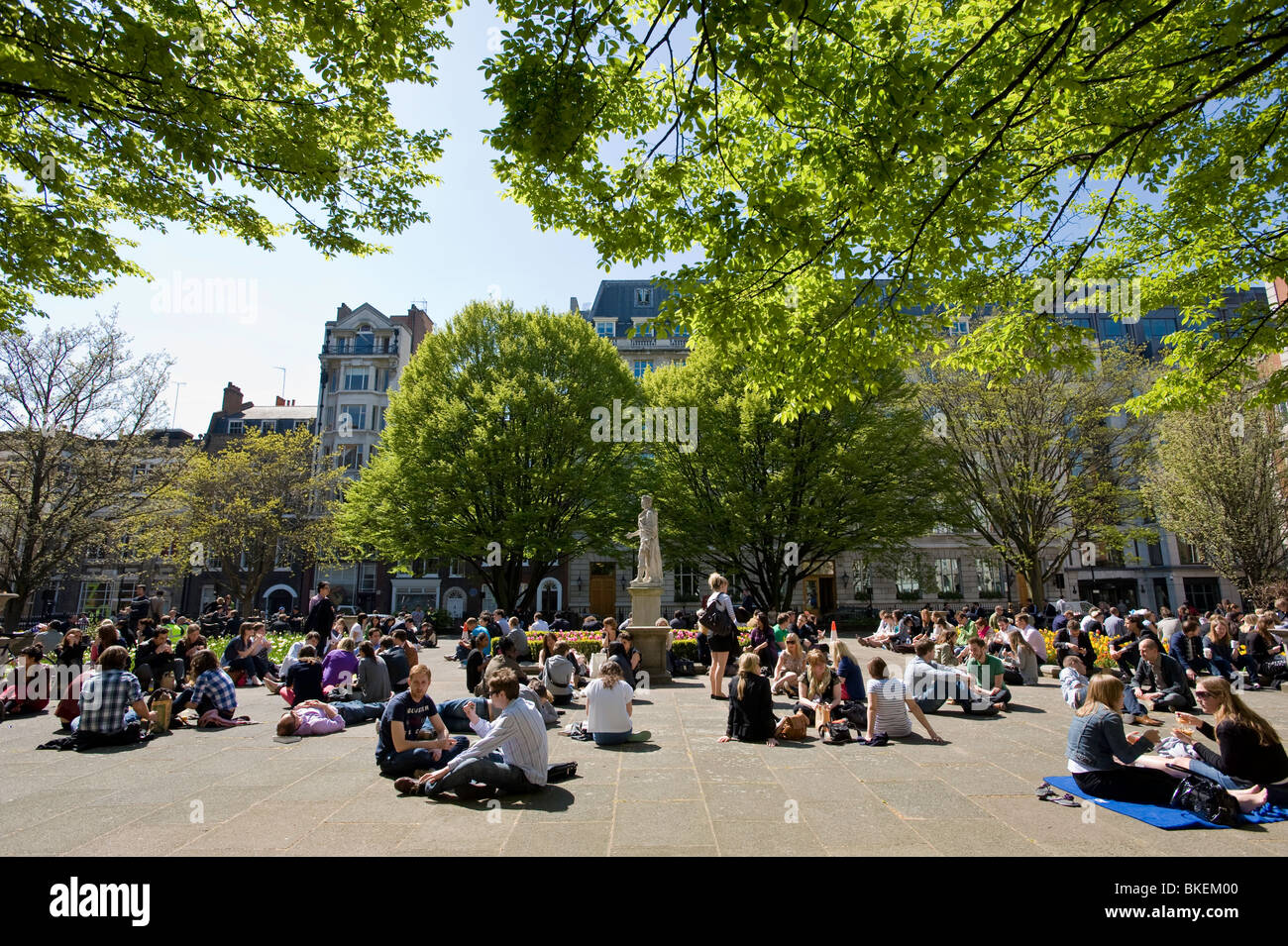 People resting on warm spring day in Golden Square, W1, London, United ...