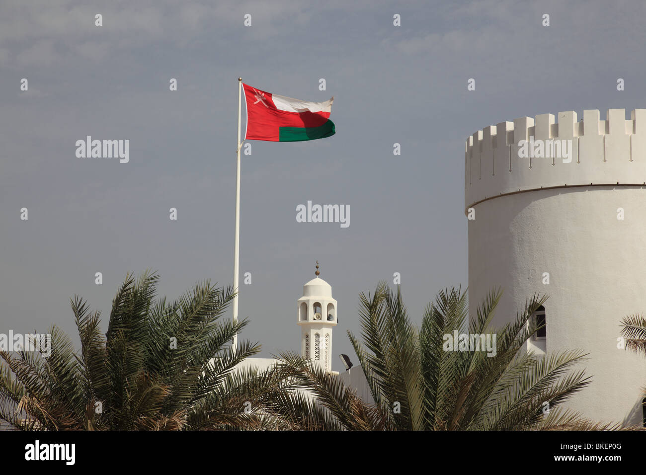 national Omani flag, minaret and castle tower in oasis Sultanate of ...