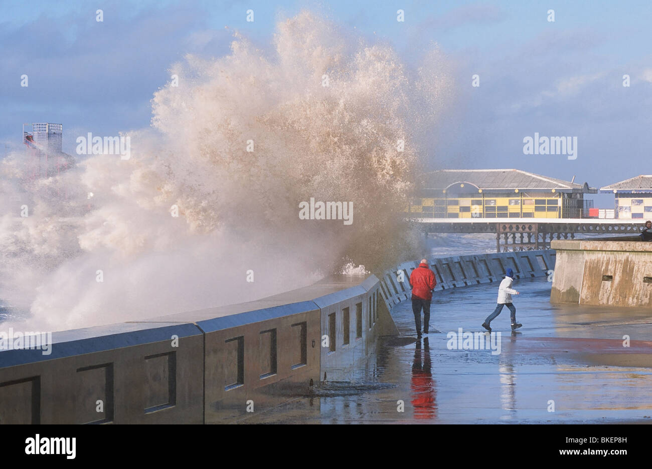 People dodging storm waves breaking over the sea wall at Blackpool ...