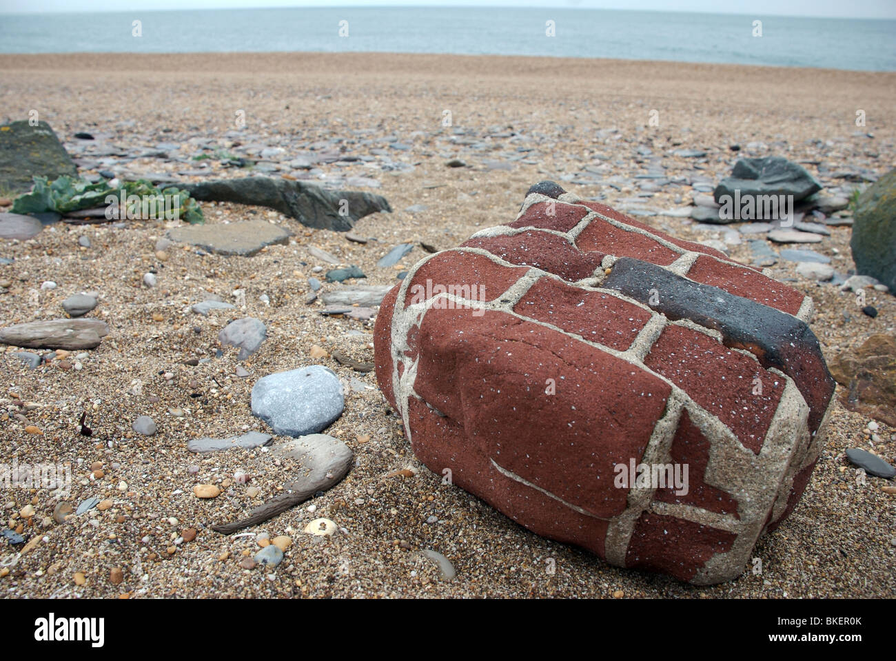 Weathered brick block on Slapton Sands beach, Torcross, Devon, UK Stock ...