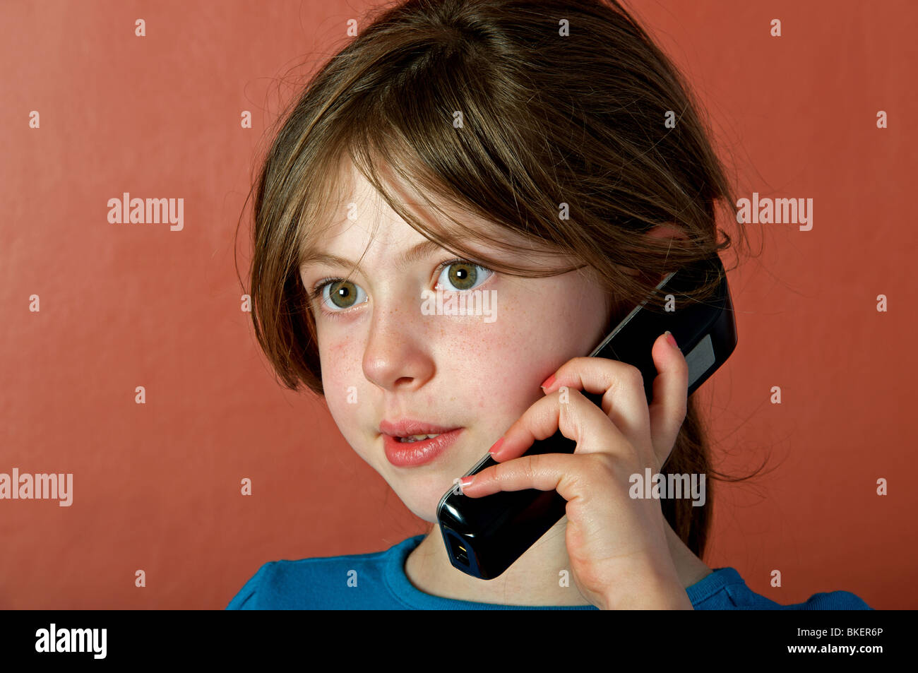 Young girl talking on a cordless telephone Stock Photo - Alamy