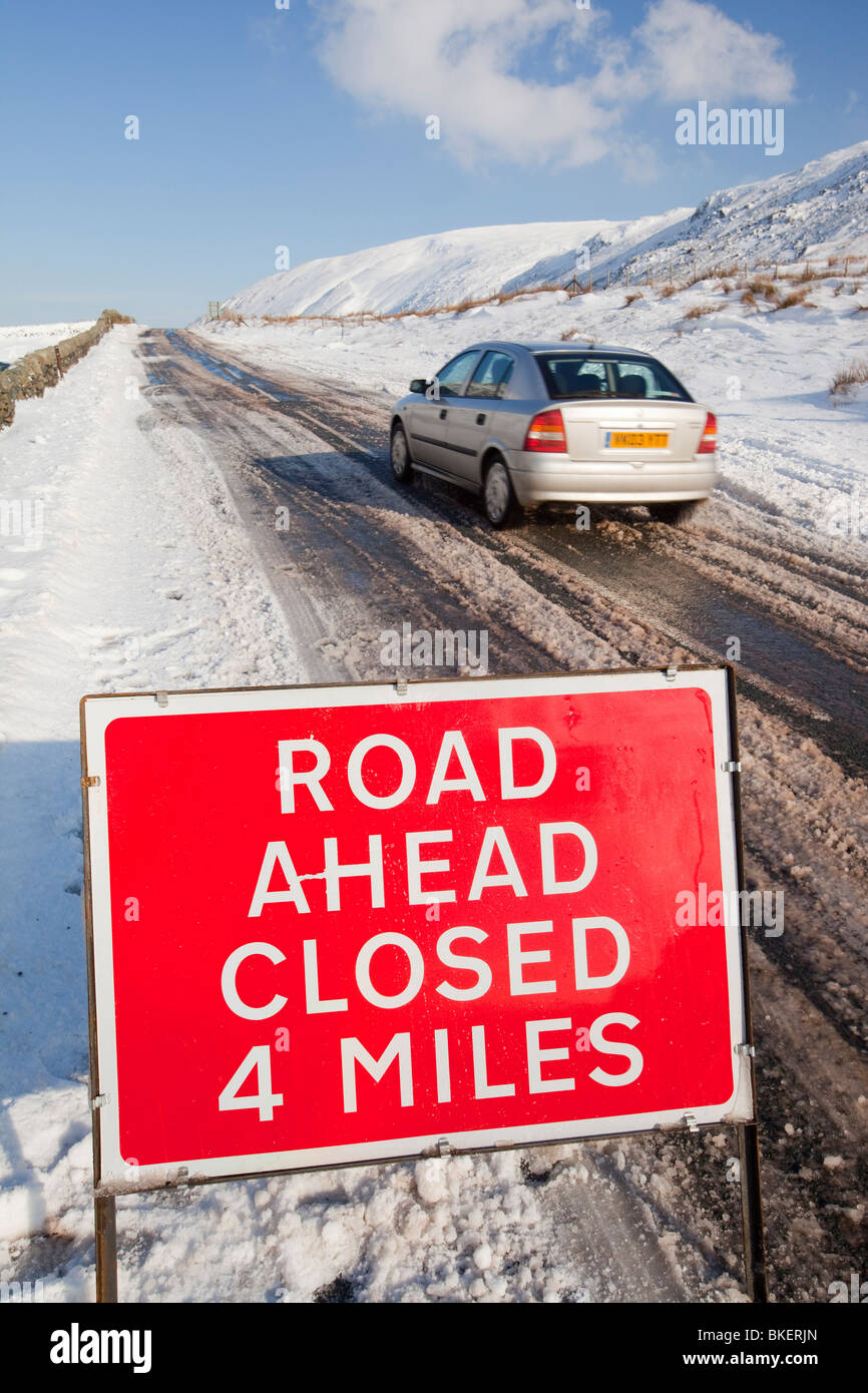 A road closed sign on top of Kirkstone Pass in the Lake District in ...