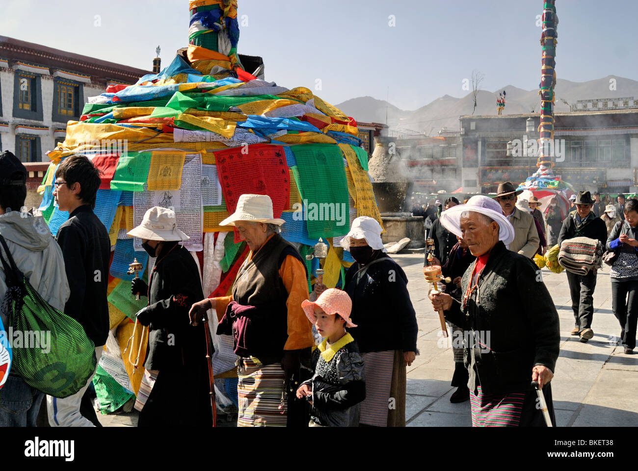 Pilgrims passing the Jokhang temple on Barkhor Square,Lhasa,Tibet Stock ...