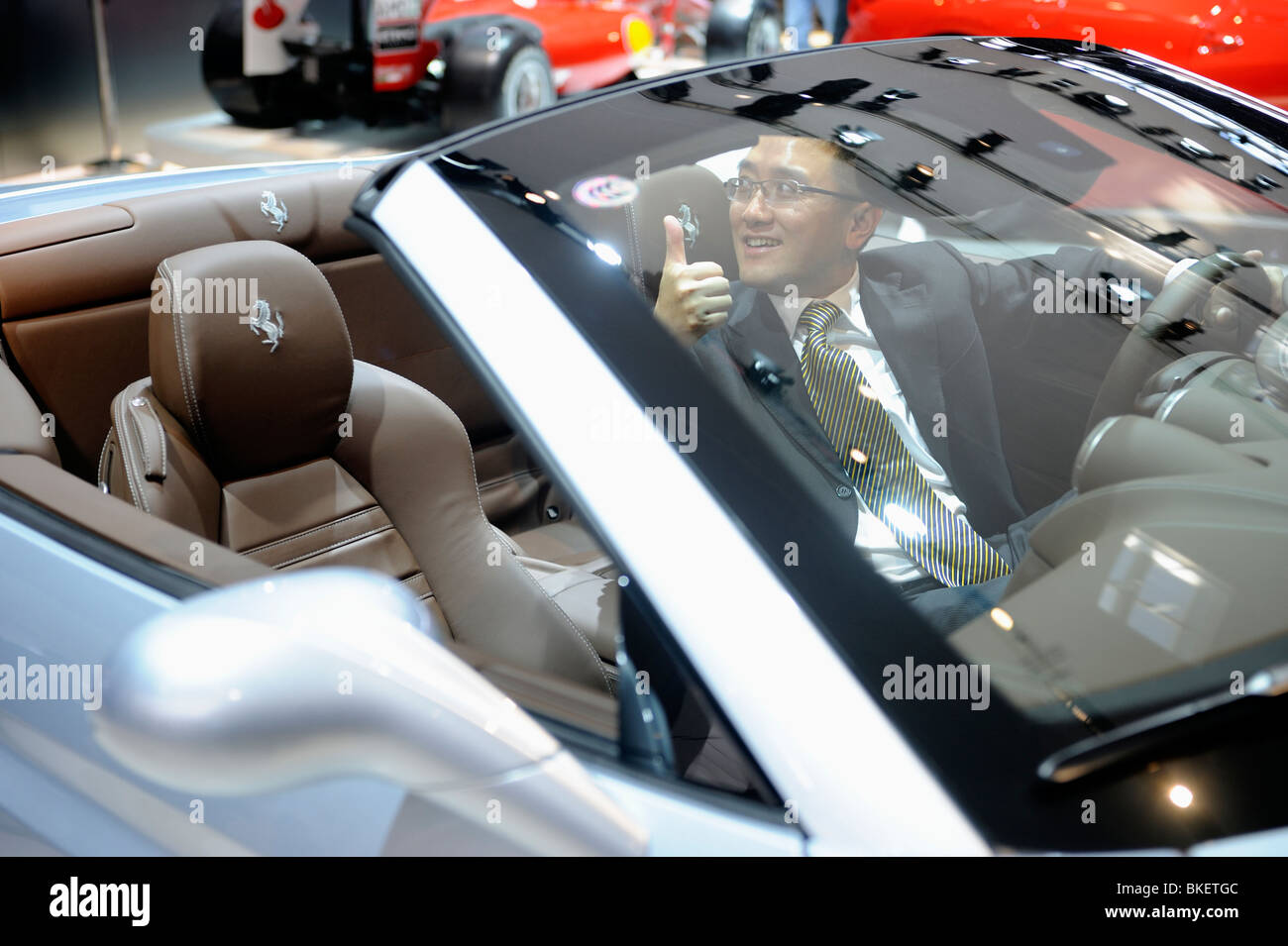 A Chinese man tries a Ferrari California at the Beijing Auto Show. 23 ...