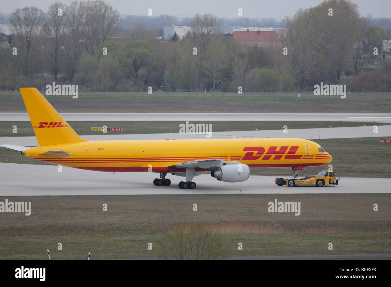 DHL airplane being towed across airport ramp apron taxiway Stock Photo ...