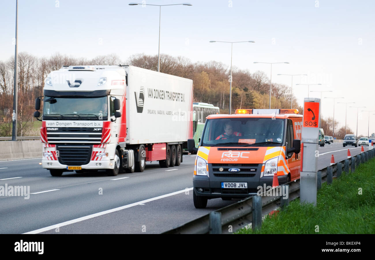 A rescue RAC van parked on the hard shoulder, lights flashing, M25 ...