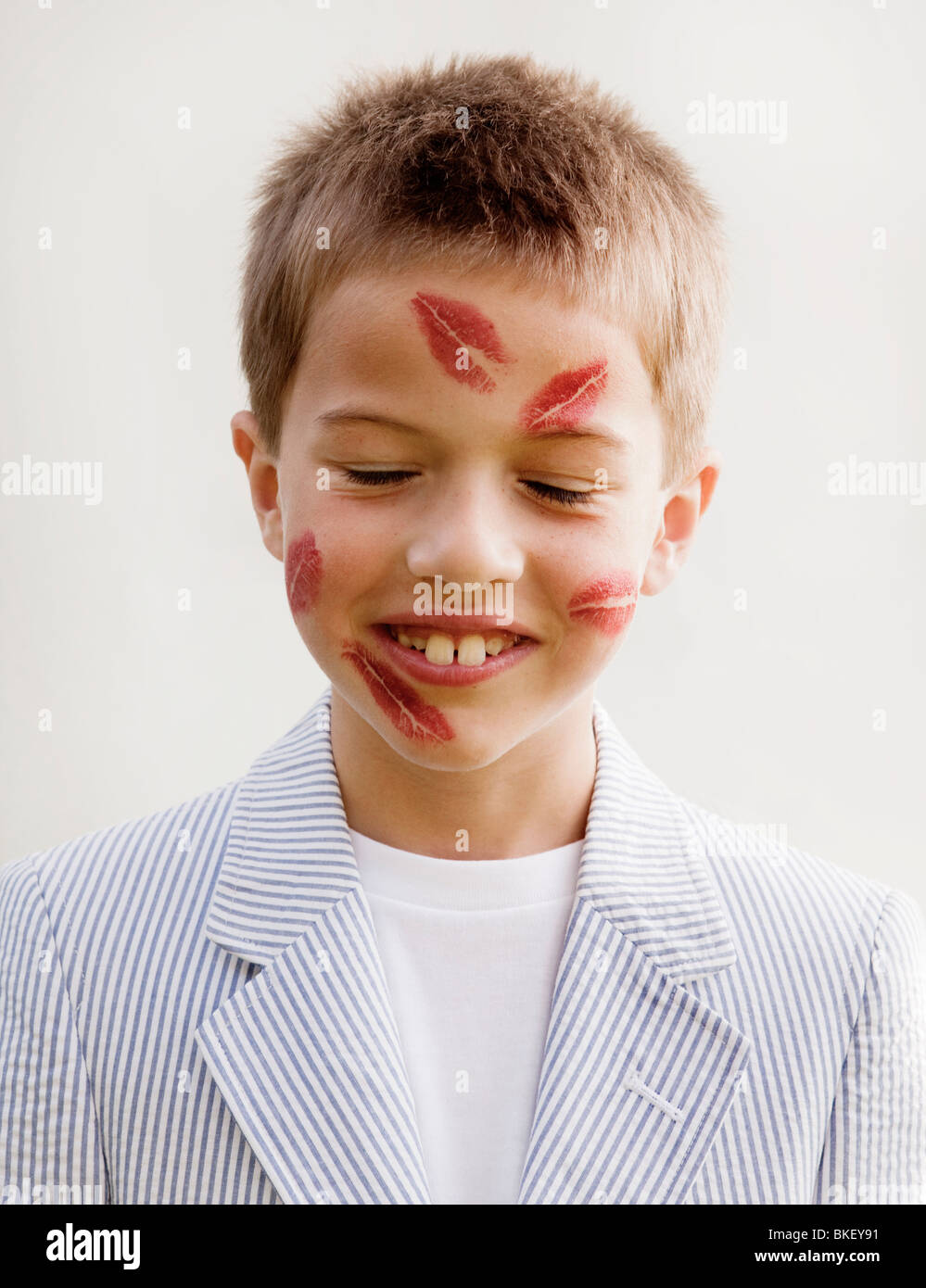 Kiss prints all over young boys face Stock Photo - Alamy
