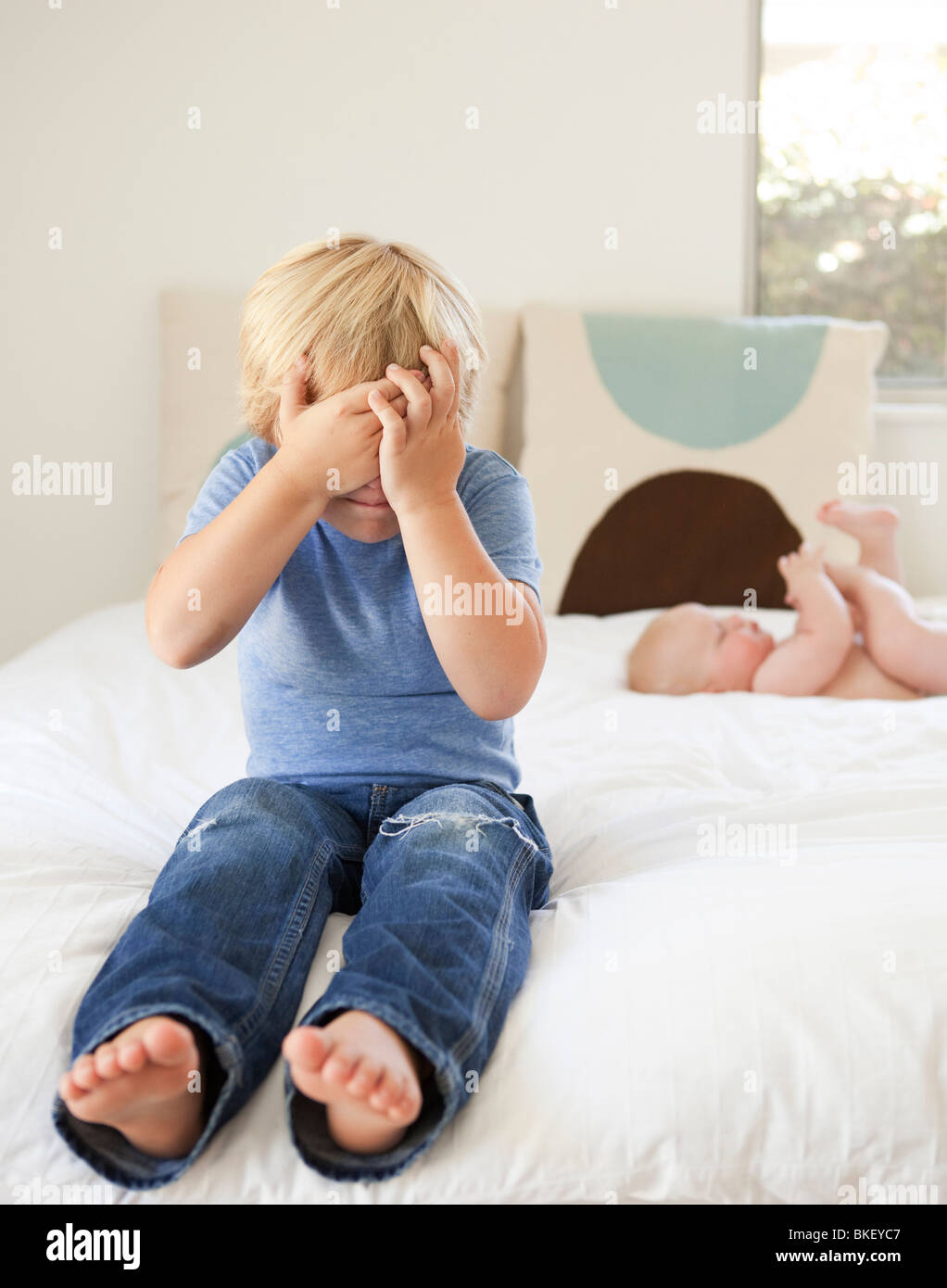 Shy boy on bed Stock Photo - Alamy