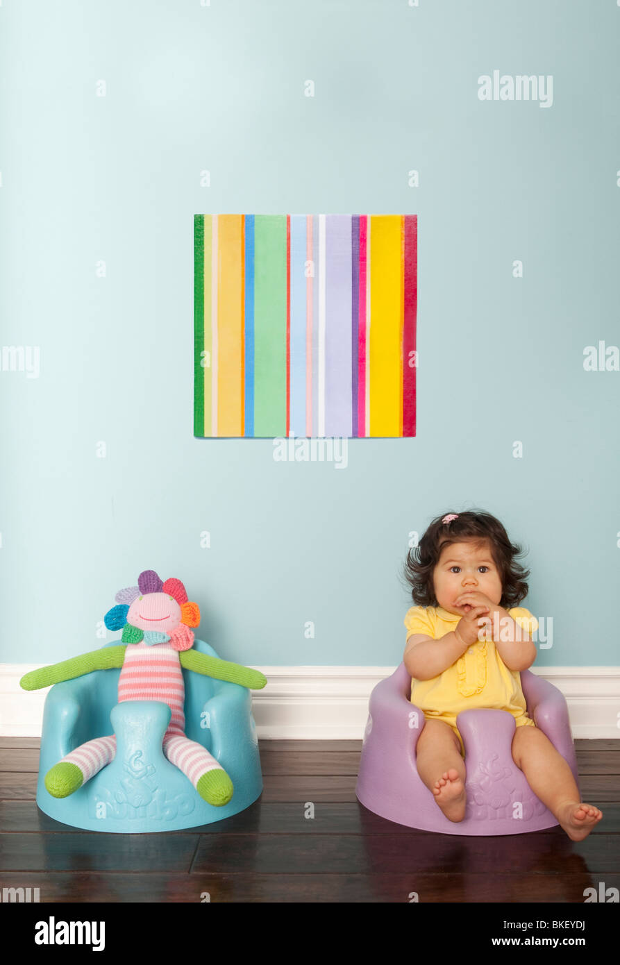 Baby girl sitting in bumbo Stock Photo - Alamy
