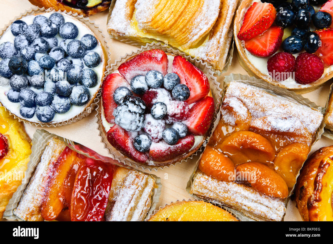 Background of assorted fresh sweet tarts and pastries from above Stock ...