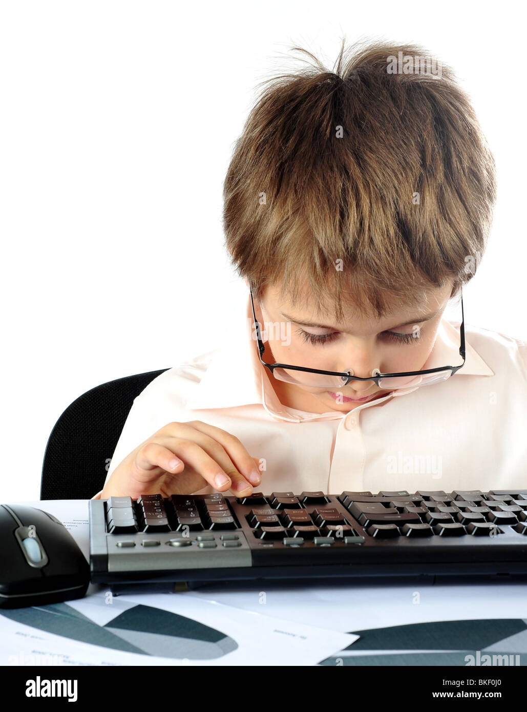Vertical image of a young boy looking sad and fed up in his office ...