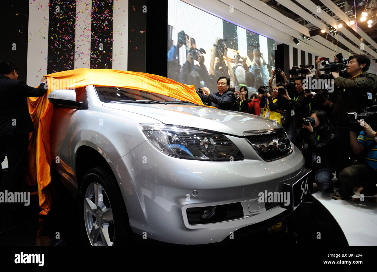 Wang Chuanfu, chairman of BYD, poses next a BYD S6 at the Beijing Auto ...