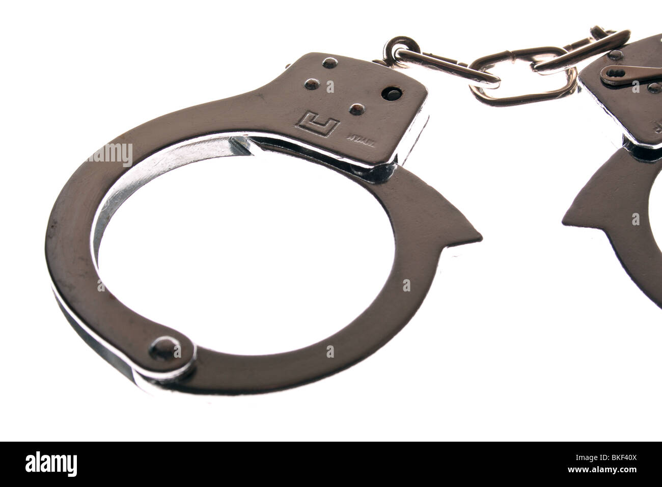 handcuffs against white Stock Photo - Alamy
