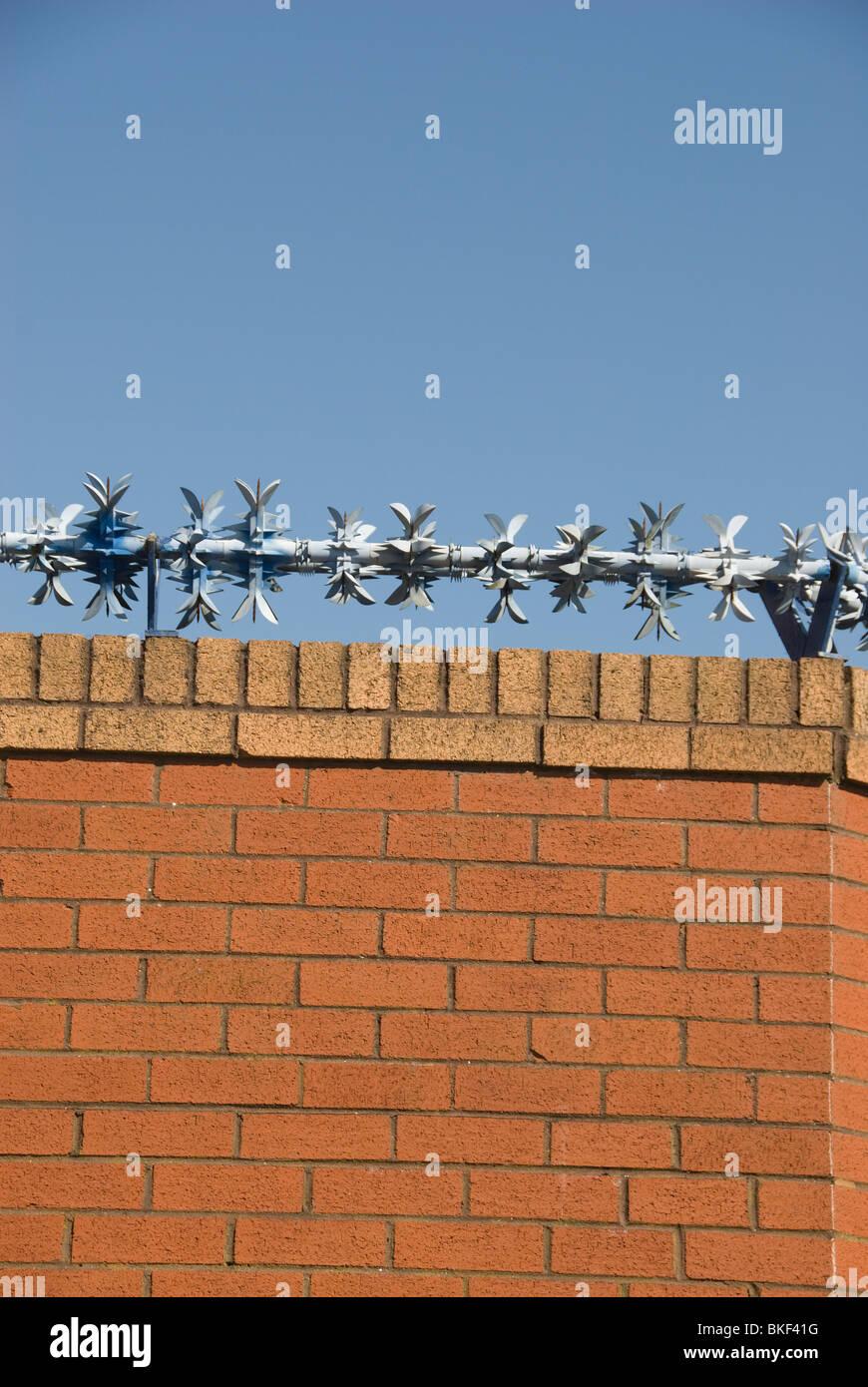 Brick wall with metal security guard Stock Photo - Alamy