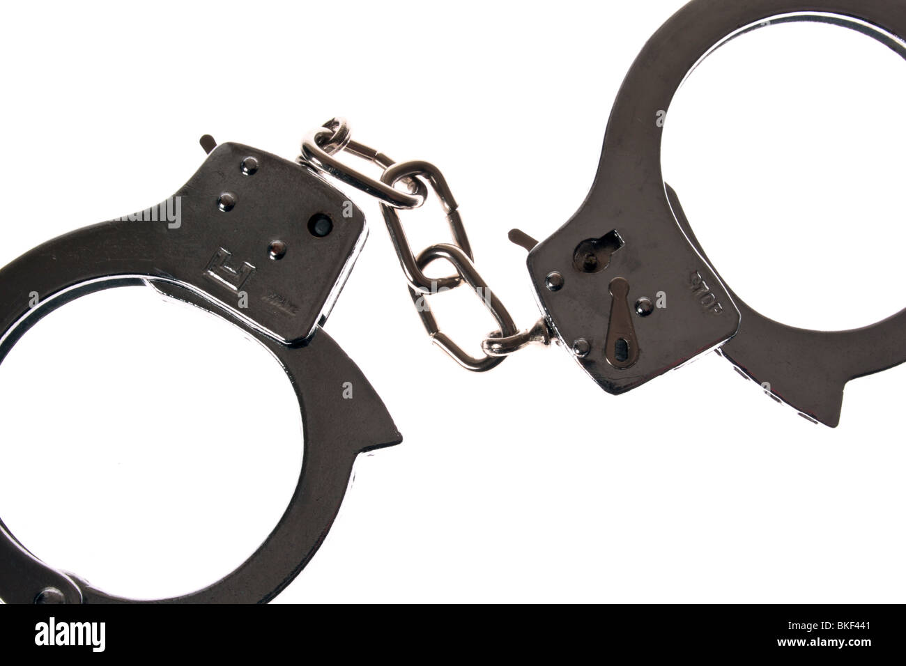 handcuffs against white Stock Photo - Alamy