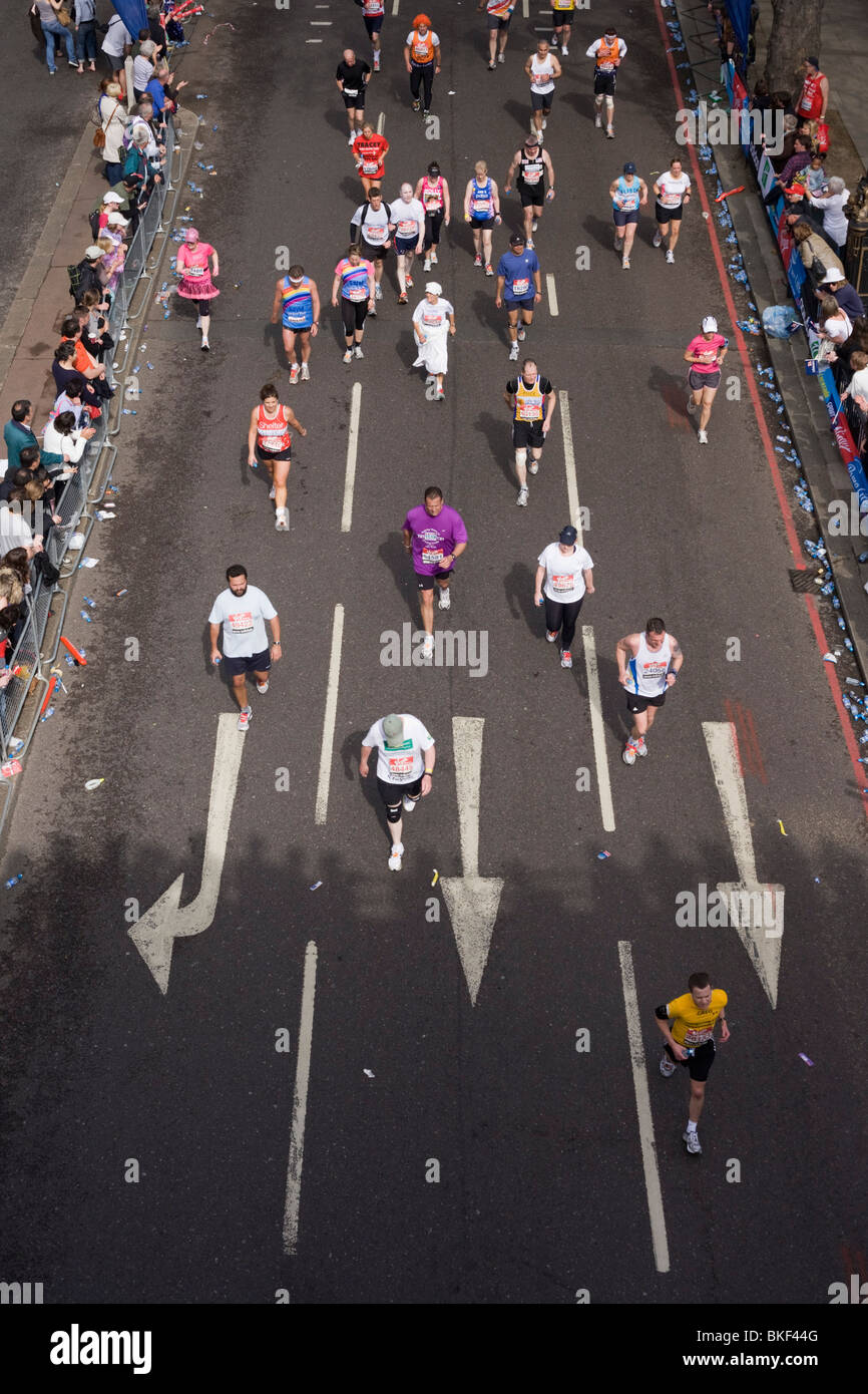 Struggling fun runners plod on along London's embankment many hours ...