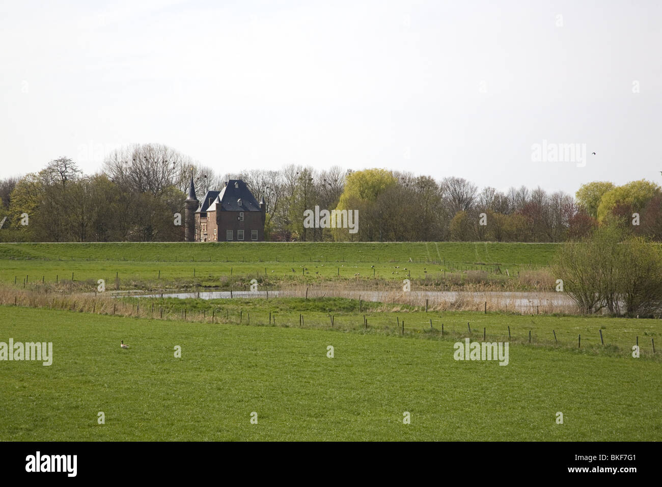 Slot Well (Well Castle) partly hidden behind the dike of the river ...