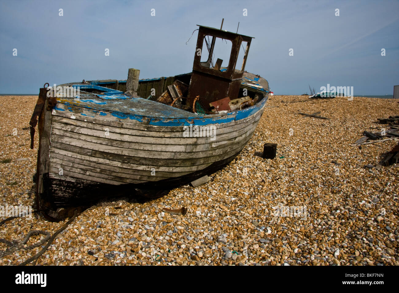 Deserted and decaying fishing boat at Dungeness Kent lies beached on ...