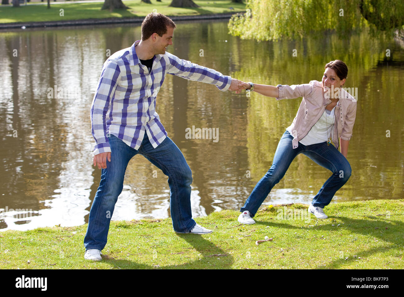 Cute young couple playing around in the park Stock Photo - Alamy