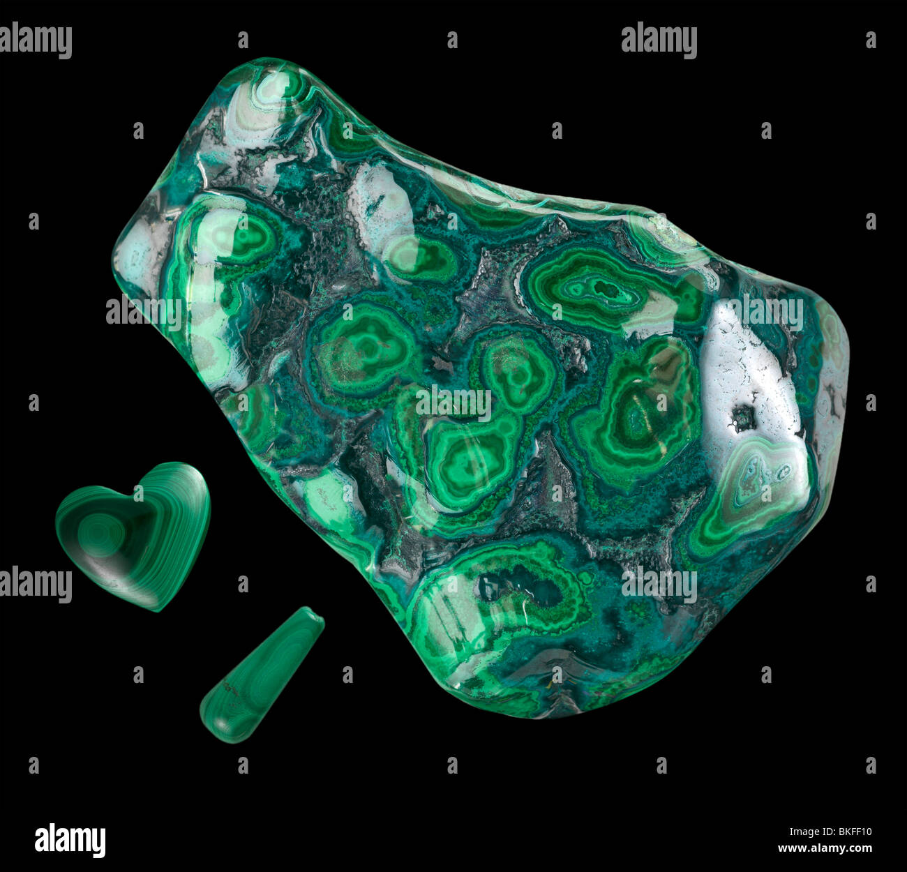 Three pieces of polished malachite against a black background Stock ...