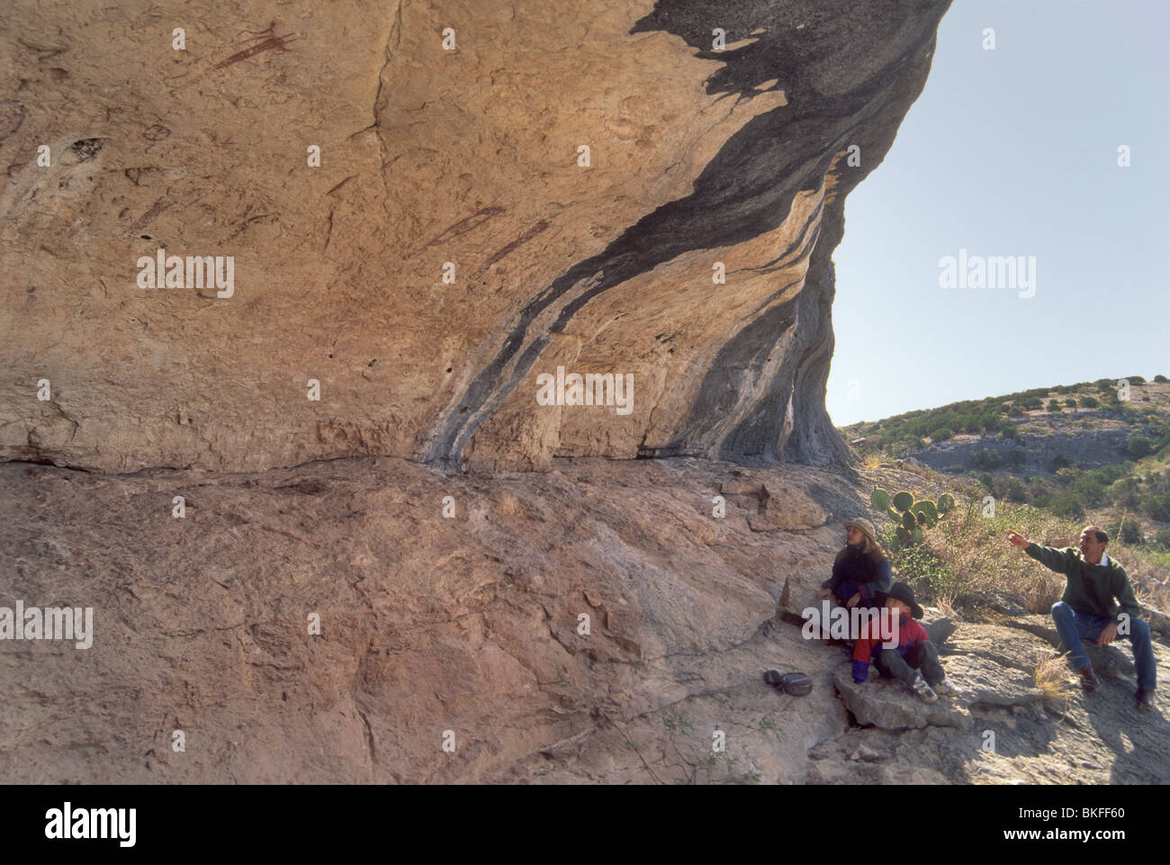 Guide and children looking at Indian pictographs at Devils River State ...