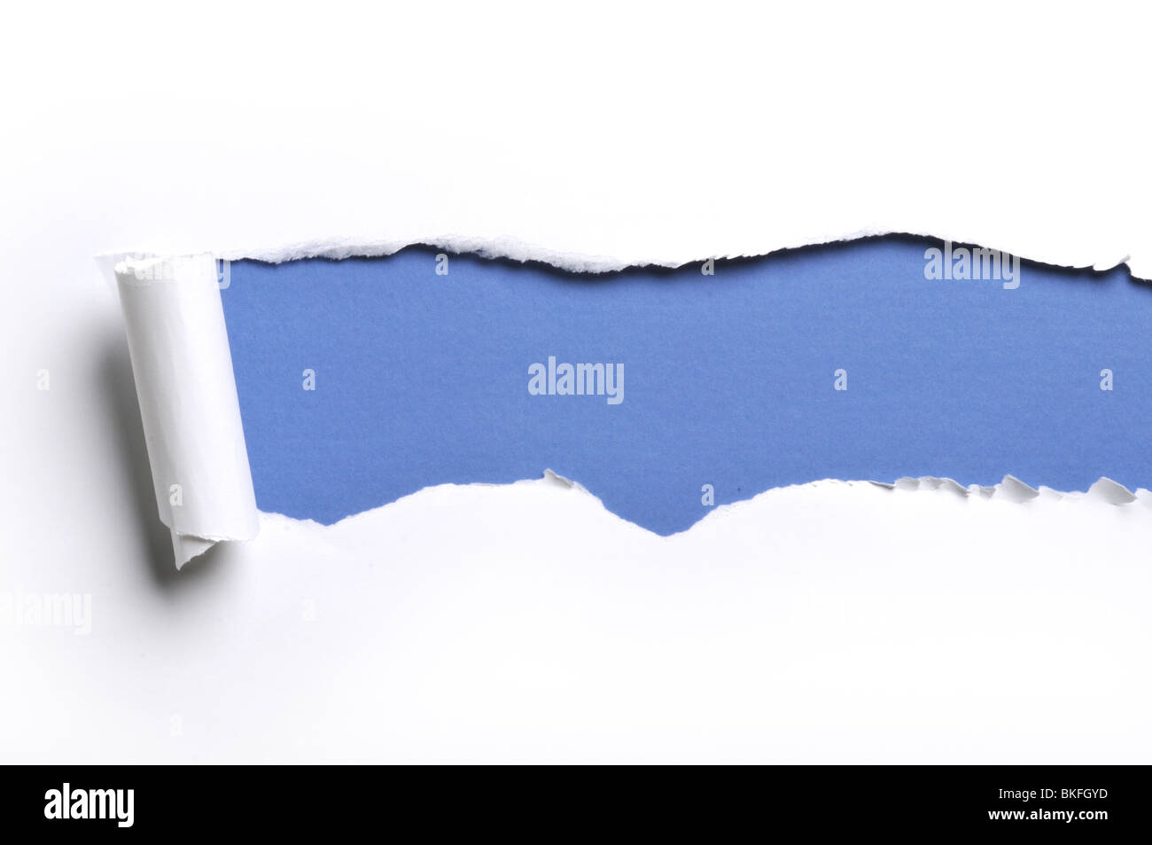 ripped white paper against a blue background Stock Photo - Alamy