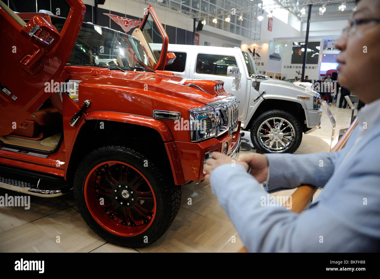 A Chinese man looks at a Longbo customized Hummer H2 at the Beiijng ...