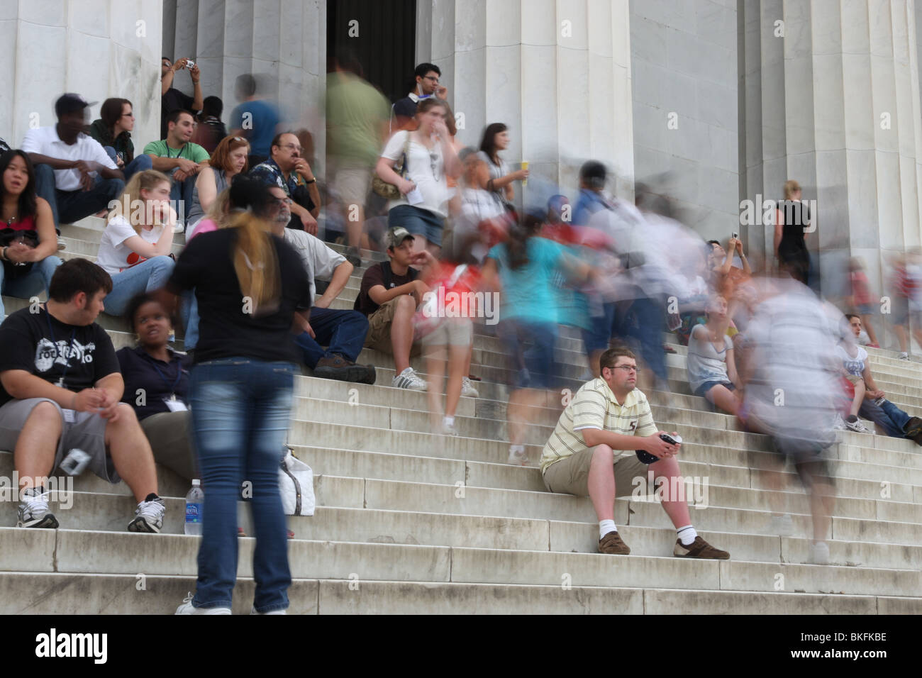 Man sits contemplating life as people and time rush by him Stock Photo ...
