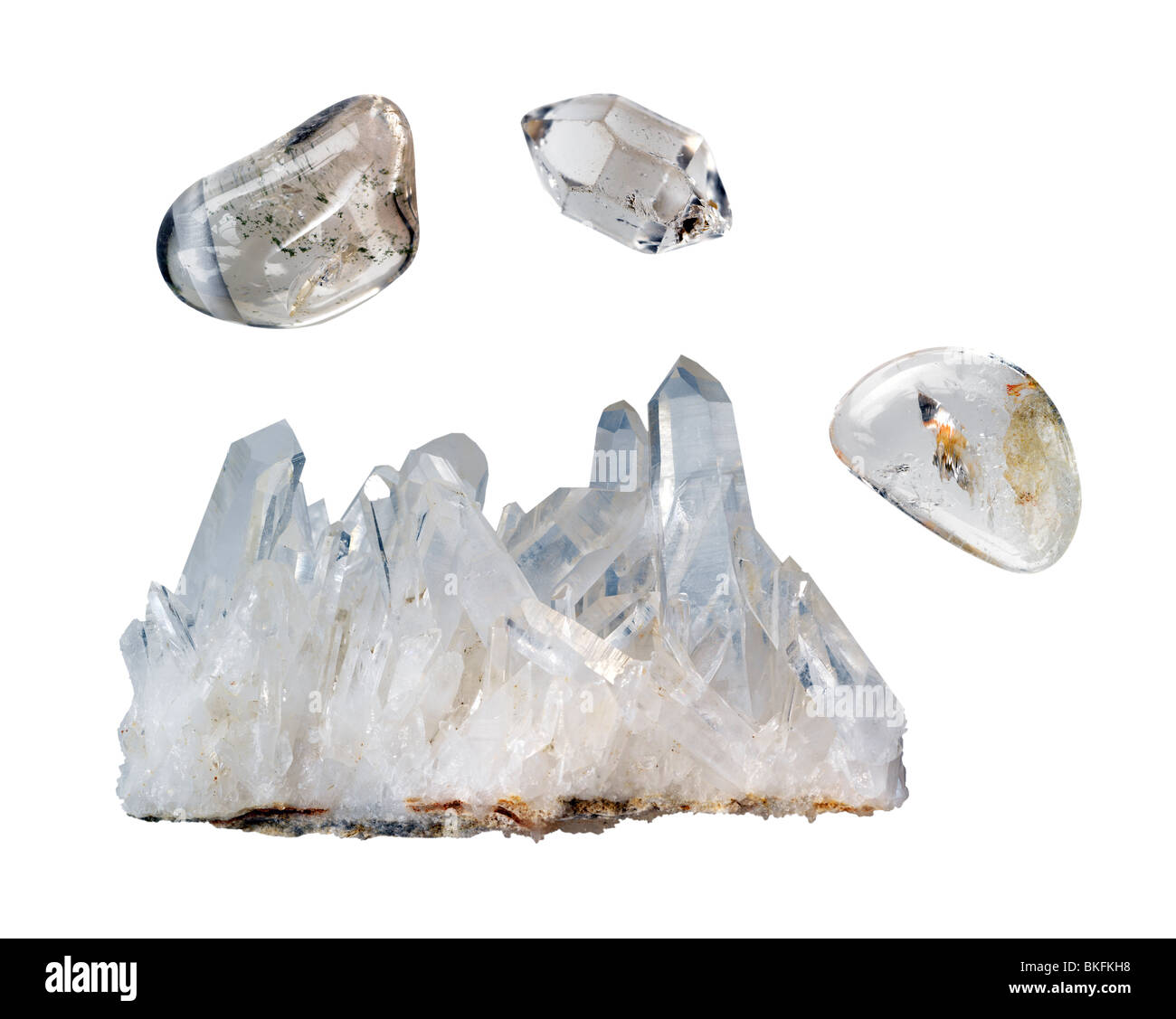 Four pieces of rock crystal against a white background. Three pieces ...