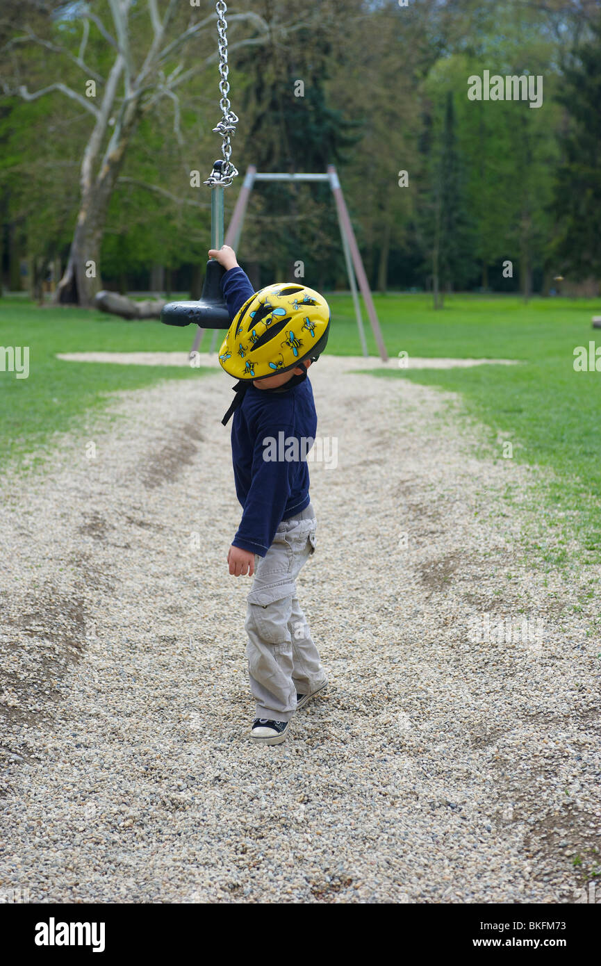 A young child boy riding a toy rope way playground summer Stock Photo ...