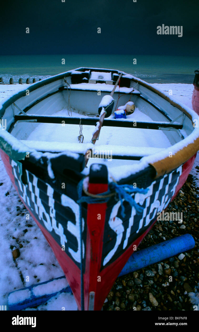 Snow-covered boat on beach Stock Photo - Alamy