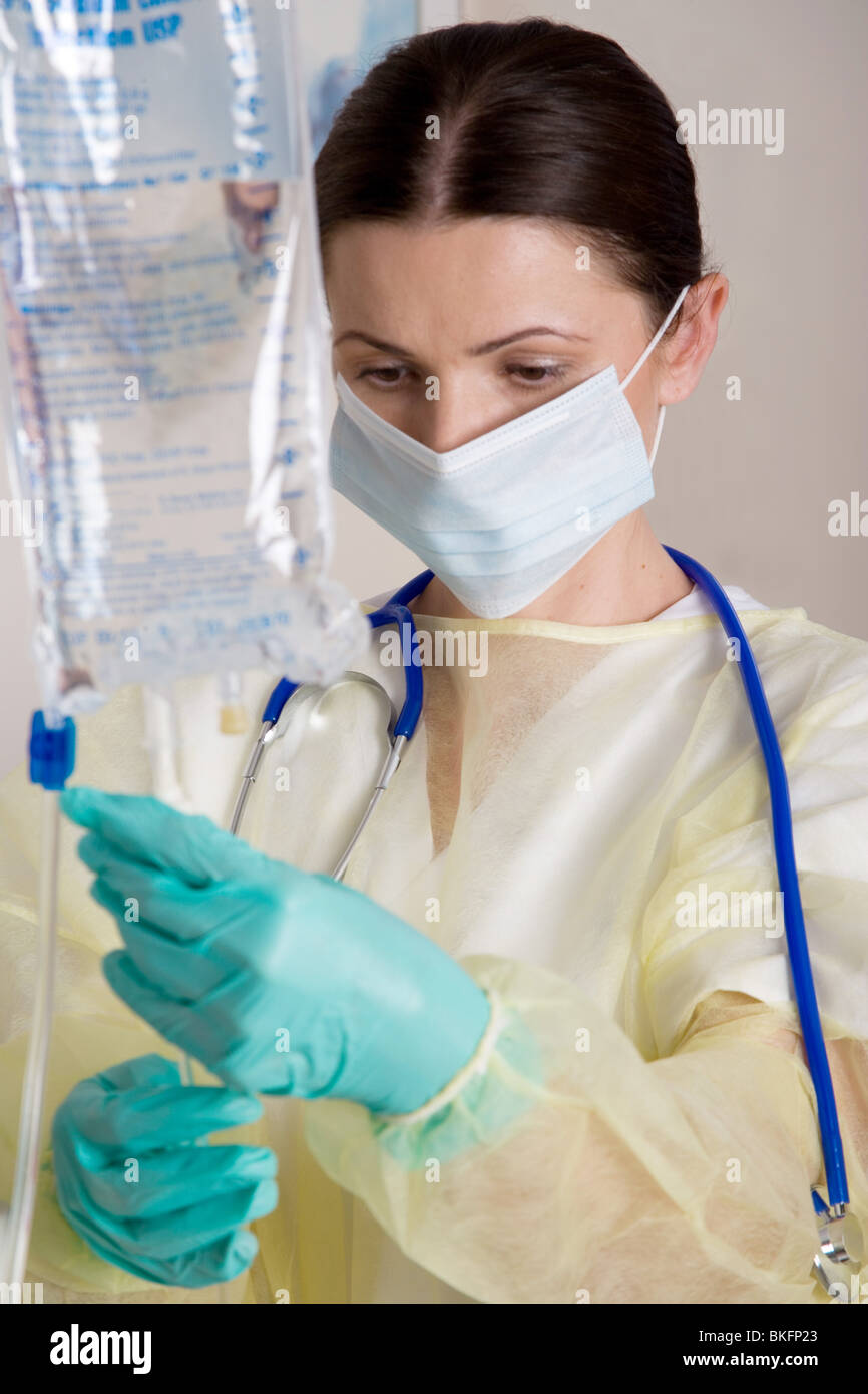 Portrait of health care worker checking IV fluid bag in Dialysis Center ...