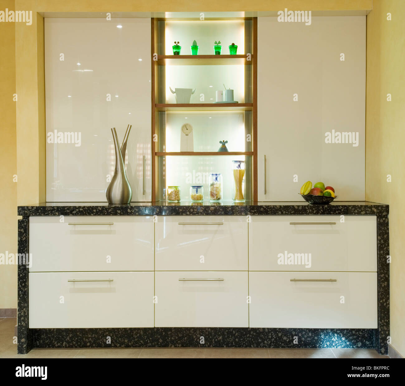 Lighted shelves in modern fitted sideboard in modern dining room Stock ...