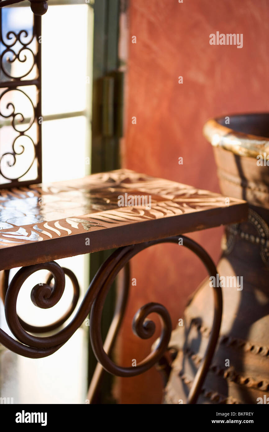 Close-up of wrought-iron table with tiled top Stock Photo - Alamy