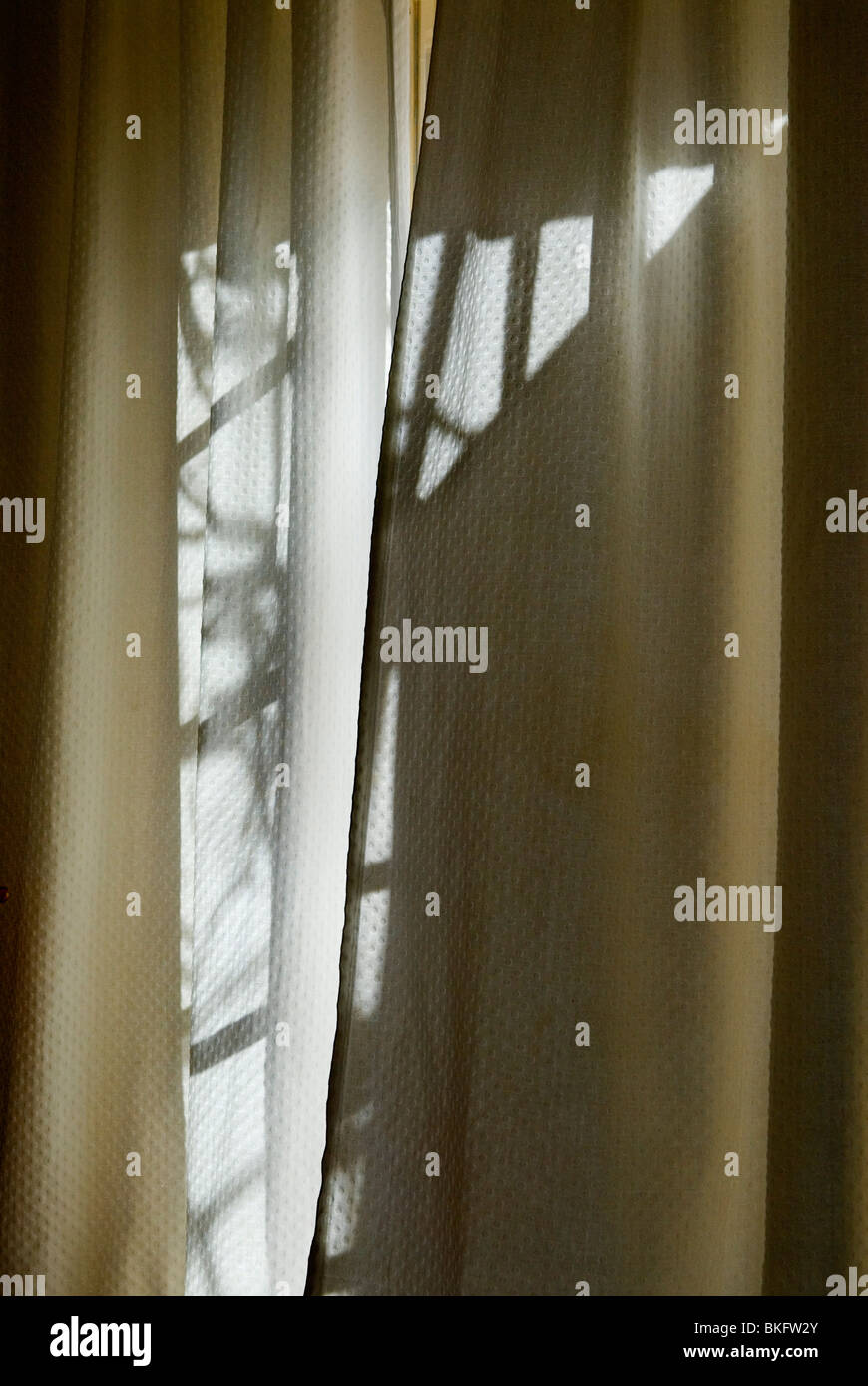Window light forming an abstract pattern from light through curtain ...