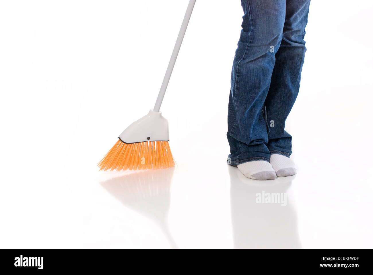 Young woman holding a modern broom with orange bristles Stock Photo - Alamy