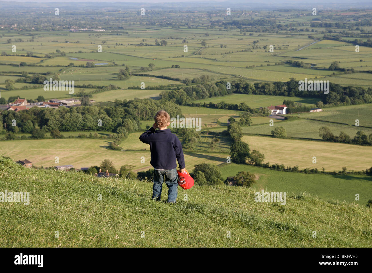 A Child looking out over a beautiful green landscape in Glastonbury ...