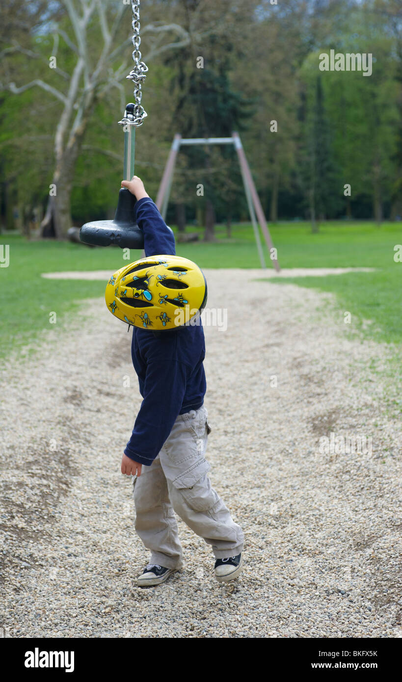 A young child boy riding a toy rope way playground summer Stock Photo ...