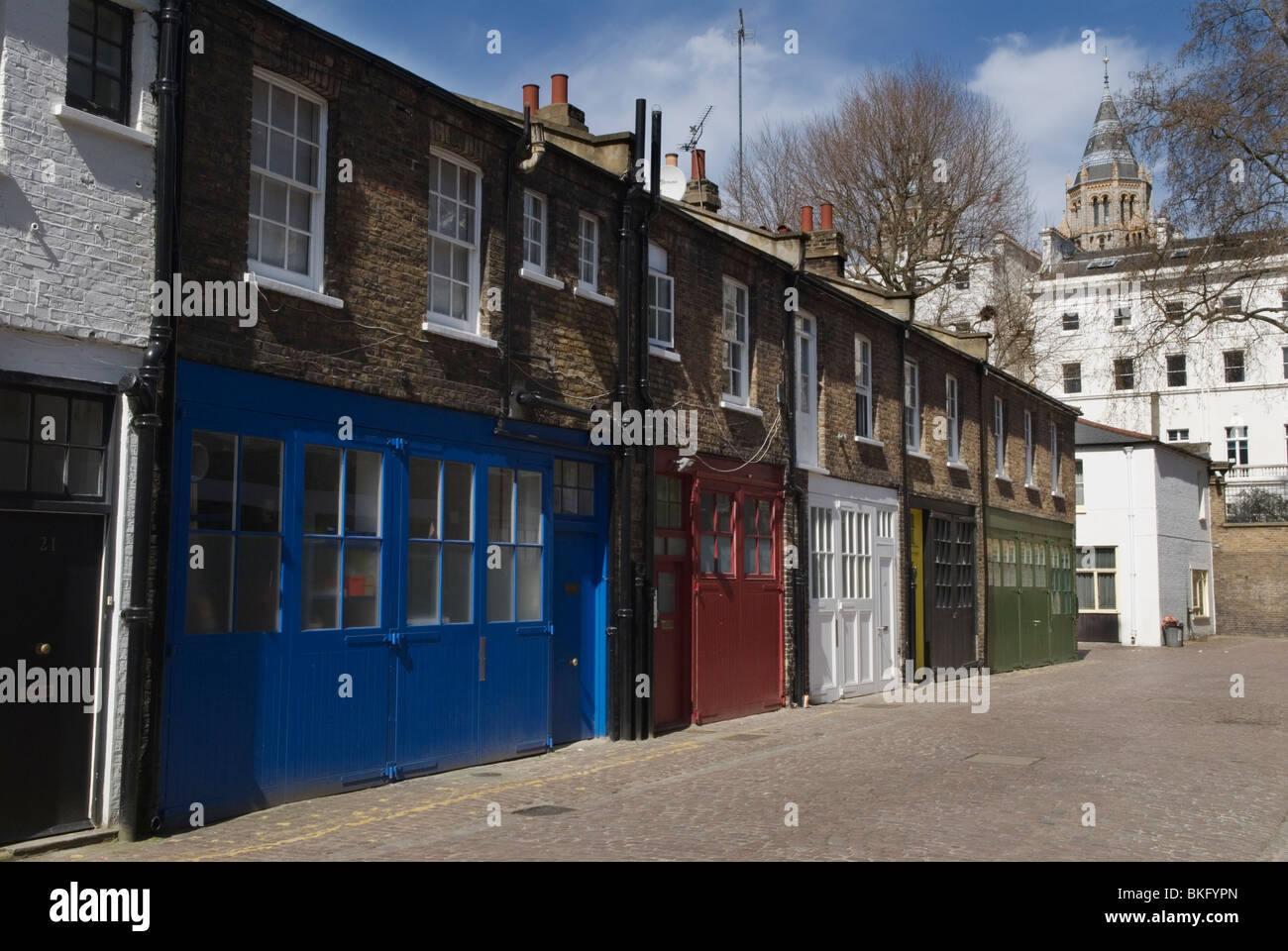 Mews housing London. Colourful garage doors no longer used as a garage ...
