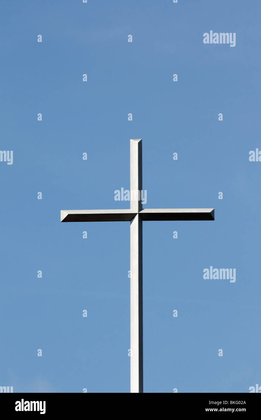 Christian church cross on blue sky background low angle from below ...