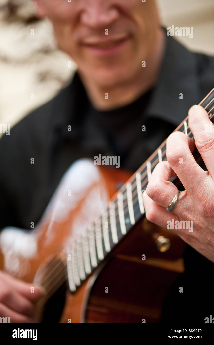 A close up view of a man's hands on his guitar Stock Photo - Alamy