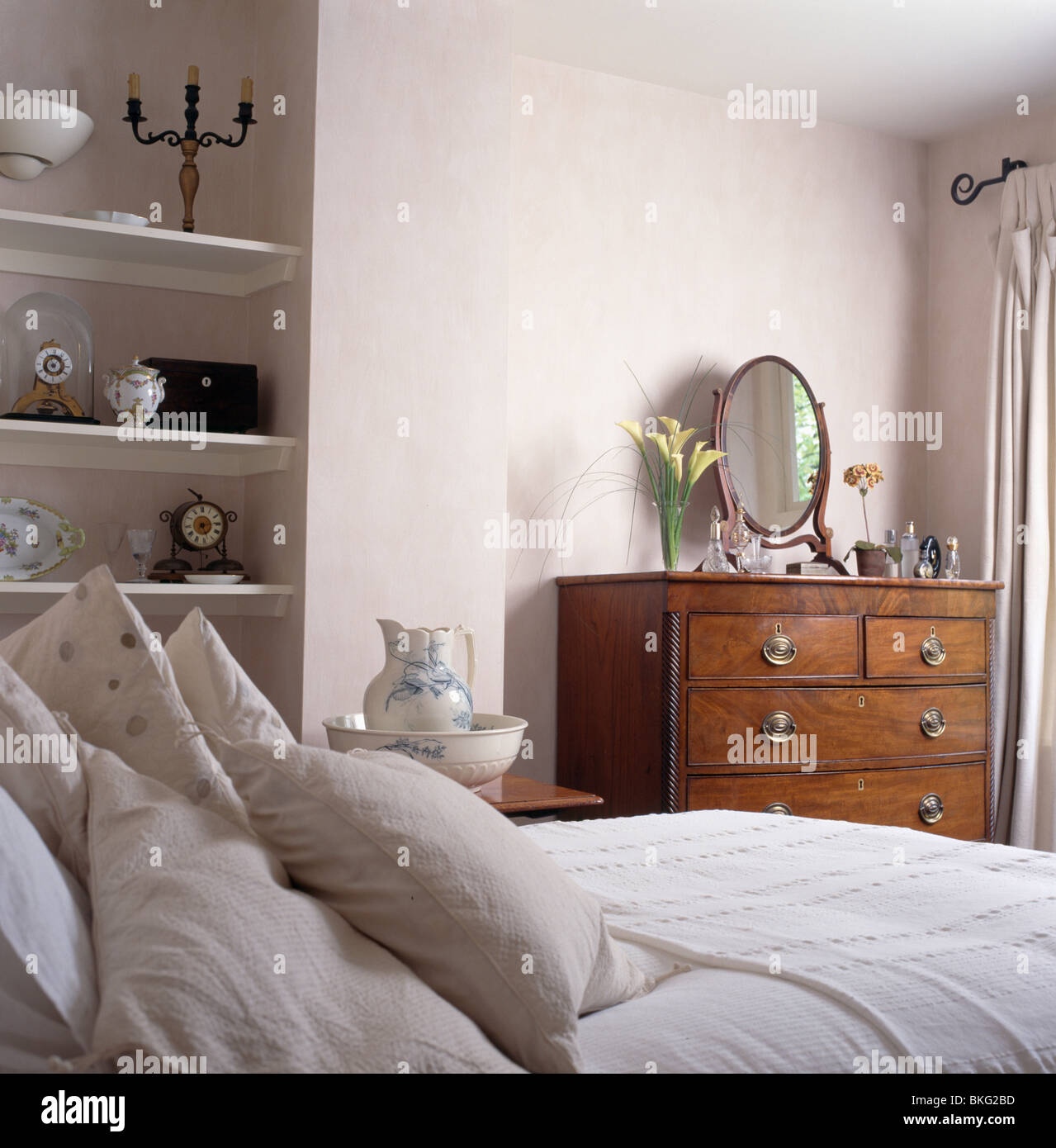 Cream linen cushions on bed in small traditional cream bedroom with ...